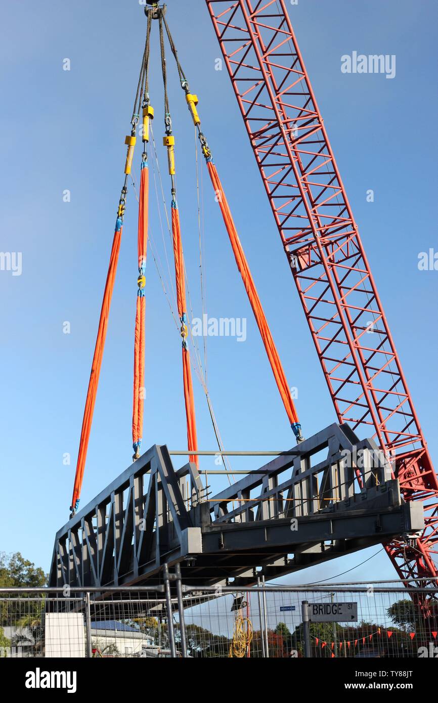Sequence pictures of large crane lifting steel section of rail bridge ...