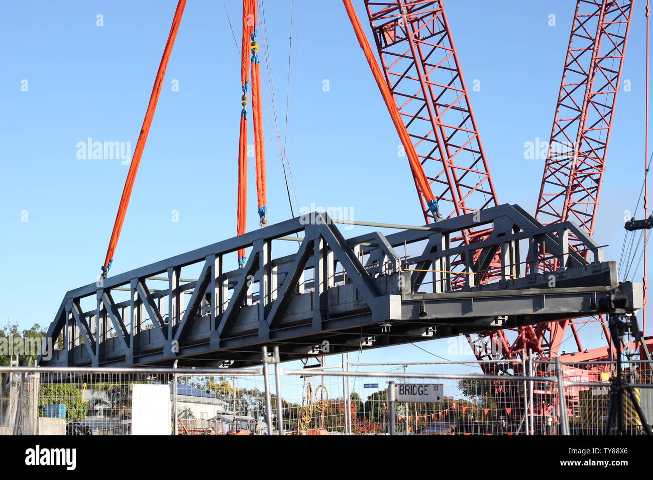 Sequence pictures of large crane lifting steel section of rail bridge ...