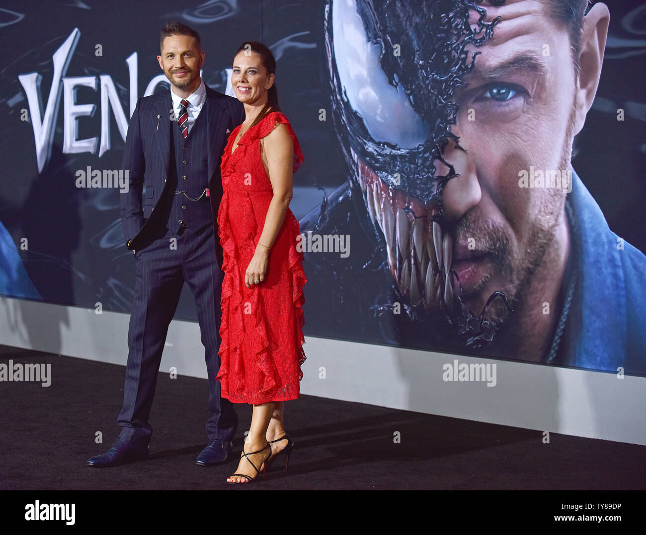 Tom Hardy (L) and Kelly Marcel attend the premiere of 'Venom' at the ...