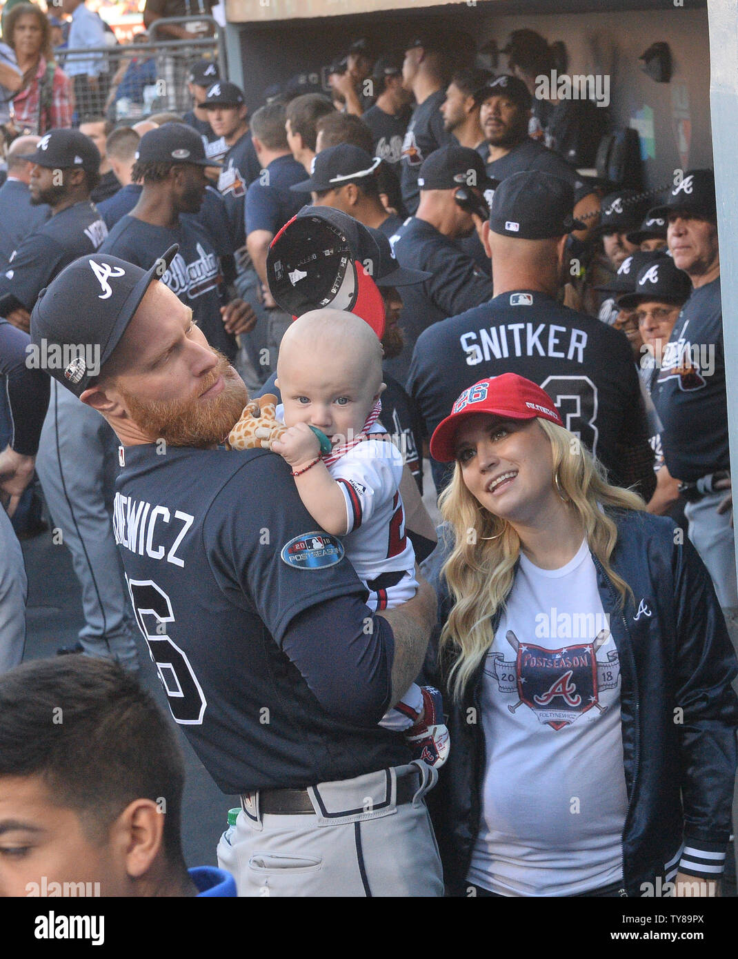 Atlanta Braves starting pitcher Mike Foltynewicz holds his son as wife ...