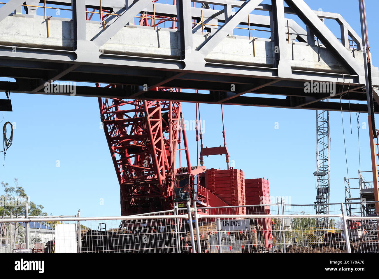 Steel section of rail lifted into place by large crane in Grafton NSW ...