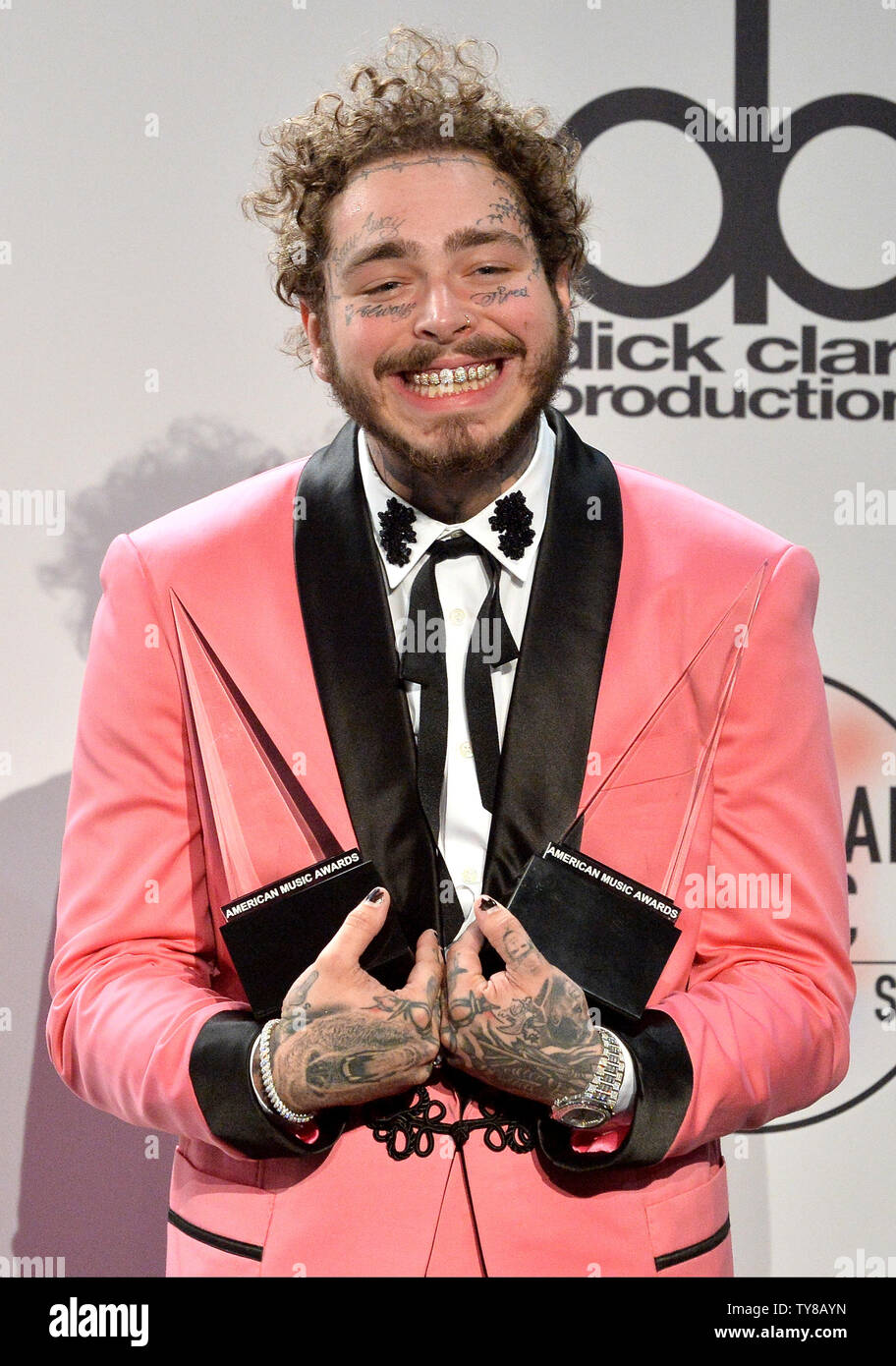 Rapper Post Malone appears backstage with his award for Favorite Male ...