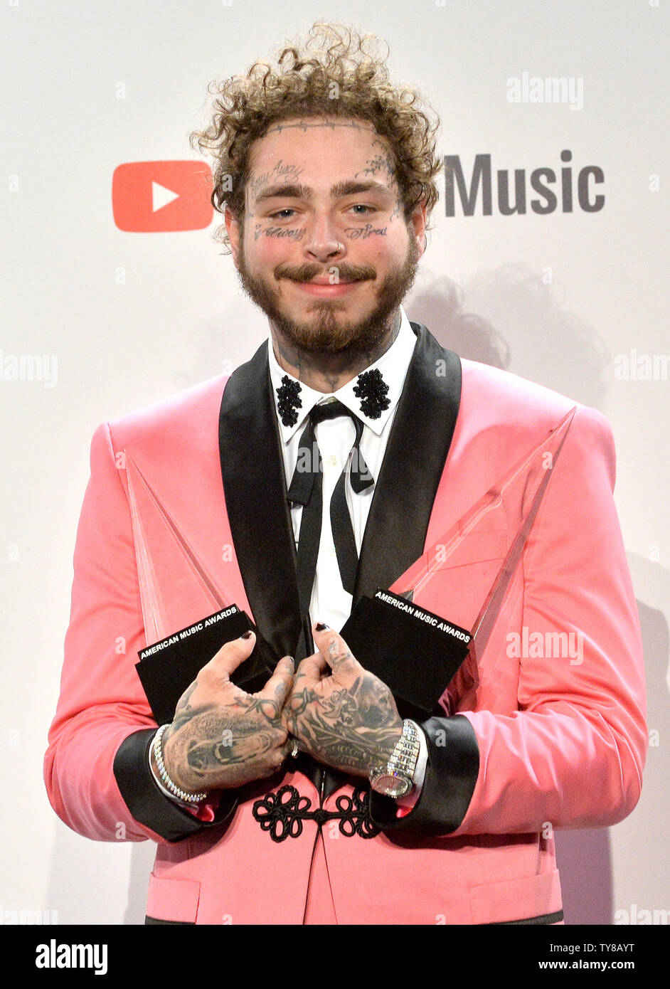Rapper Post Malone appears backstage with his award for Favorite Male ...