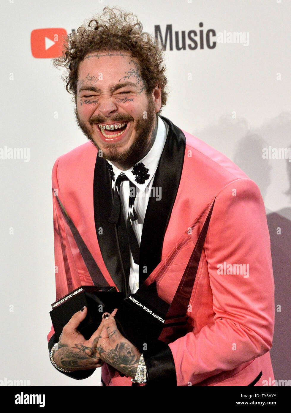 Rapper Post Malone appears backstage with his award for Favorite Male ...