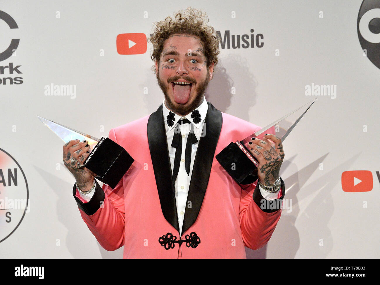 Rapper Post Malone appears backstage with his award for Favorite Male ...