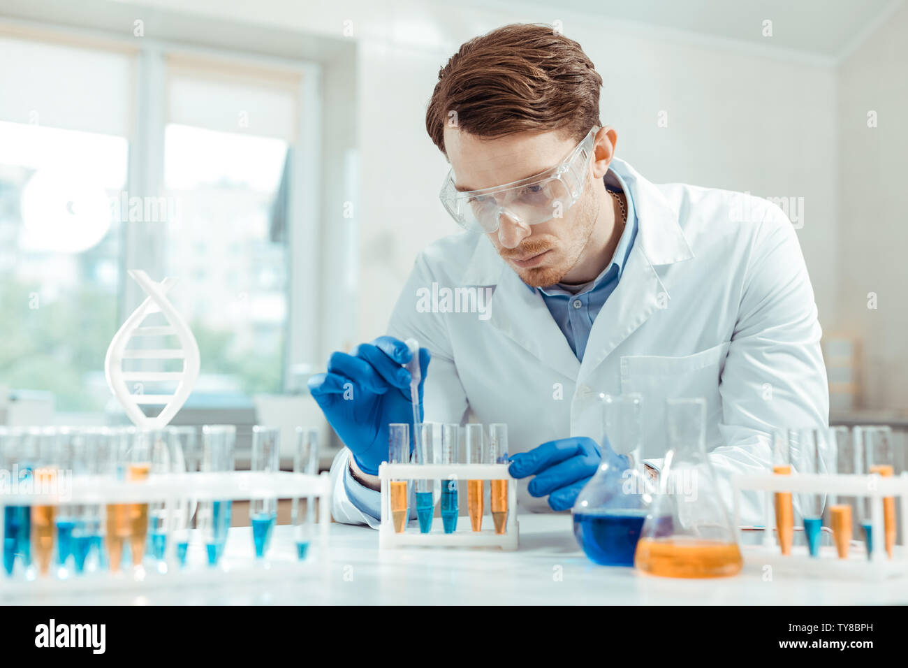 Serious handsome scientist wearing special protective glasses Stock ...