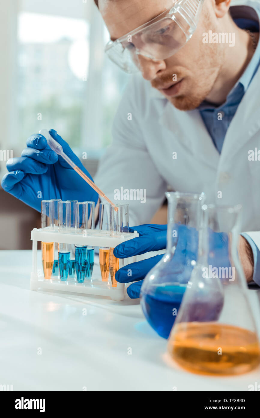 Smart male scientist focusing on his task Stock Photo - Alamy