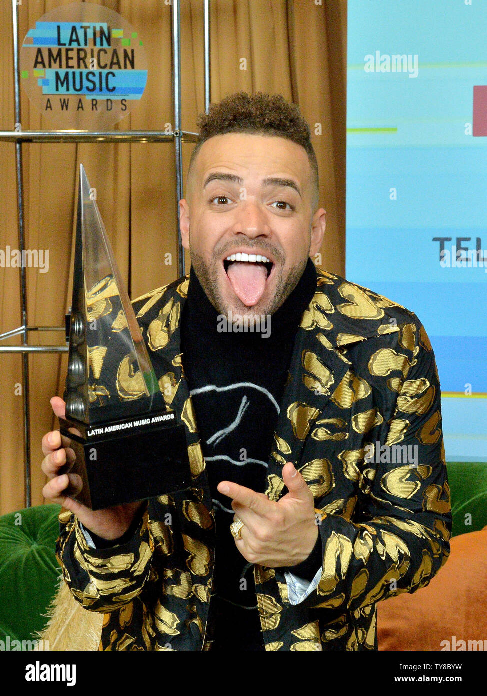 Nacho appears backstage with his award for Favorite Tropical Song for ...
