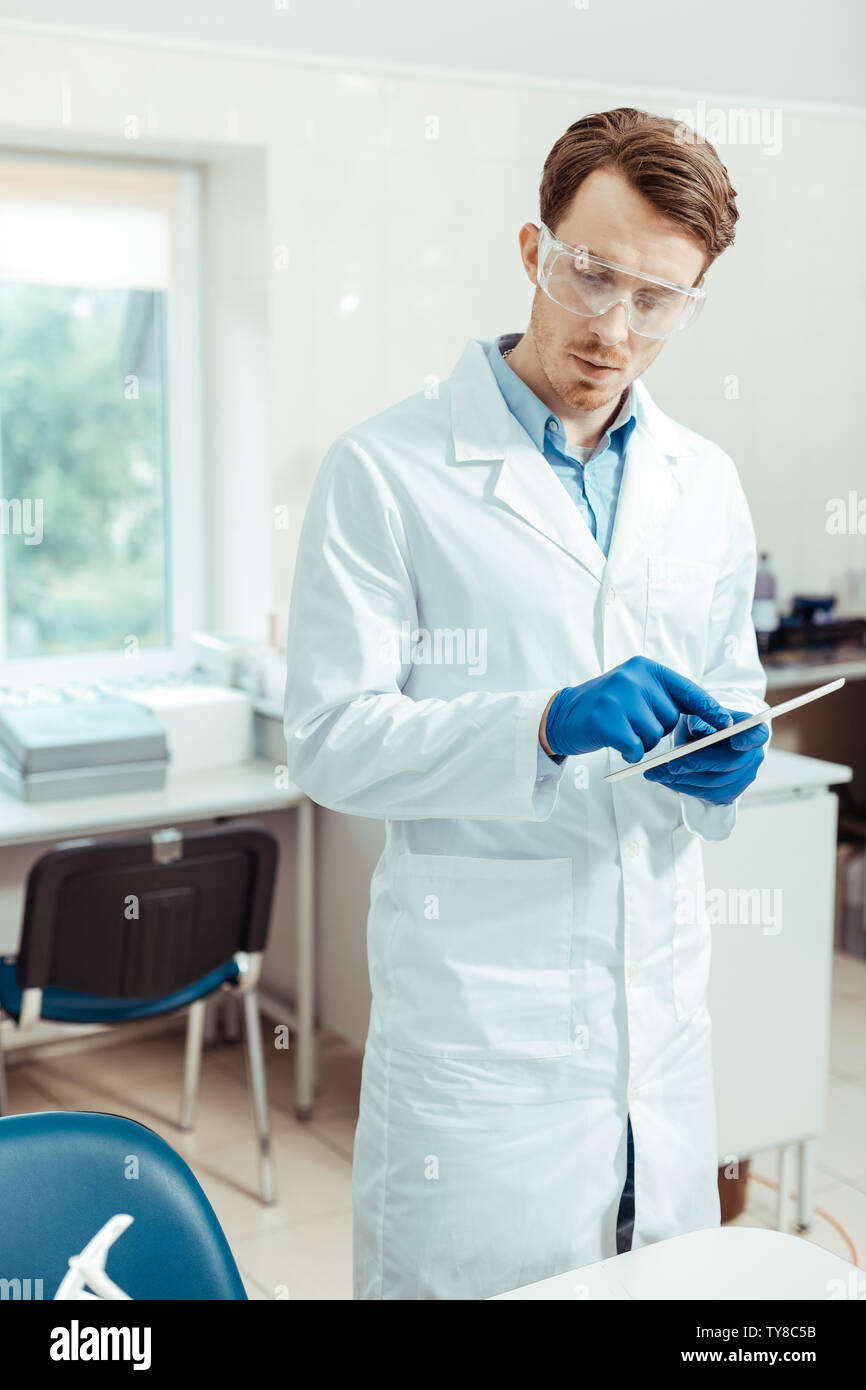 Professional serious scientist standing in the lab Stock Photo - Alamy