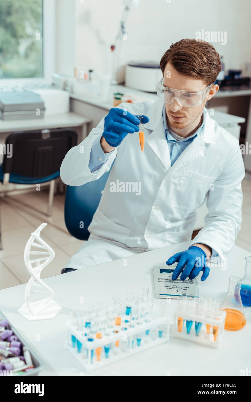 Professional smart male scientist conducting a research Stock Photo - Alamy