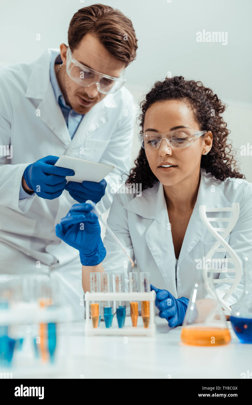 Nice young scientists conducting a research together Stock Photo - Alamy