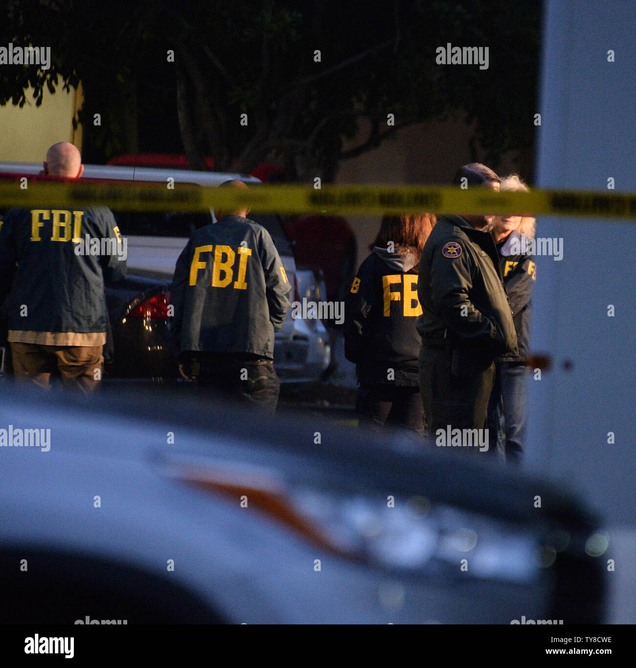 FBI personel gather in a secured area near the Borderline Bar and Grill ...