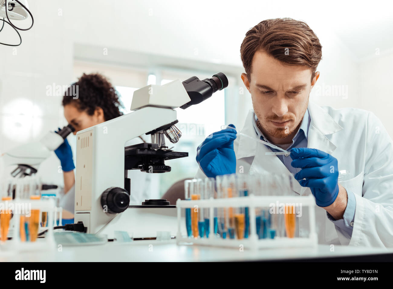 Smart young man working as a biologist Stock Photo - Alamy
