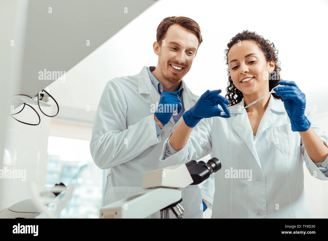 Happy positive biologists conducting a successful research Stock Photo ...