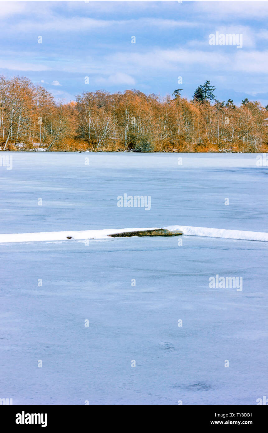 beautiful winter scene with frozen lake, covered with shattering ice ...