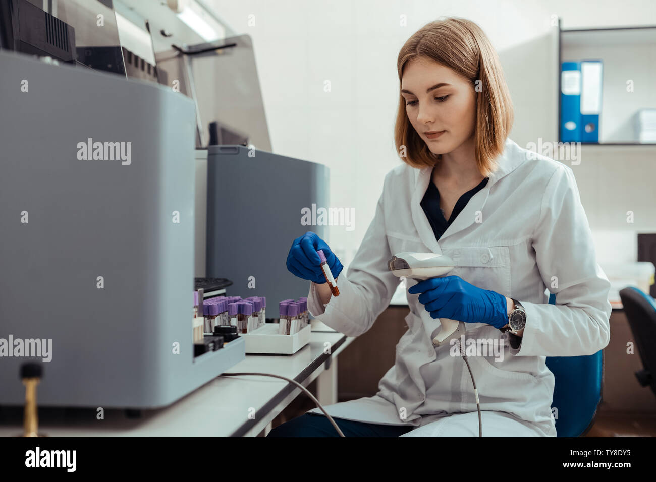 Professional female lab worker holding a test tube with blood Stock ...