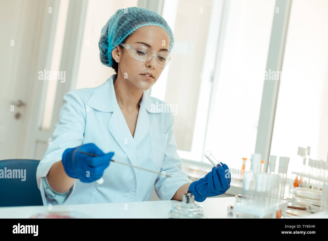 Smart female scientist focusing on her research Stock Photo - Alamy