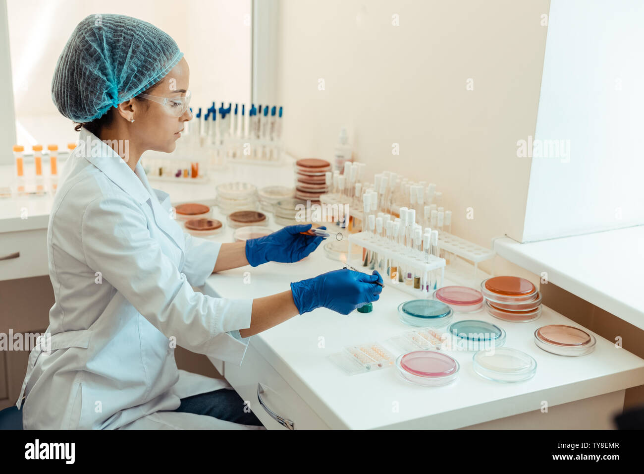 Serious nice woman wearing a laboratory uniform Stock Photo - Alamy