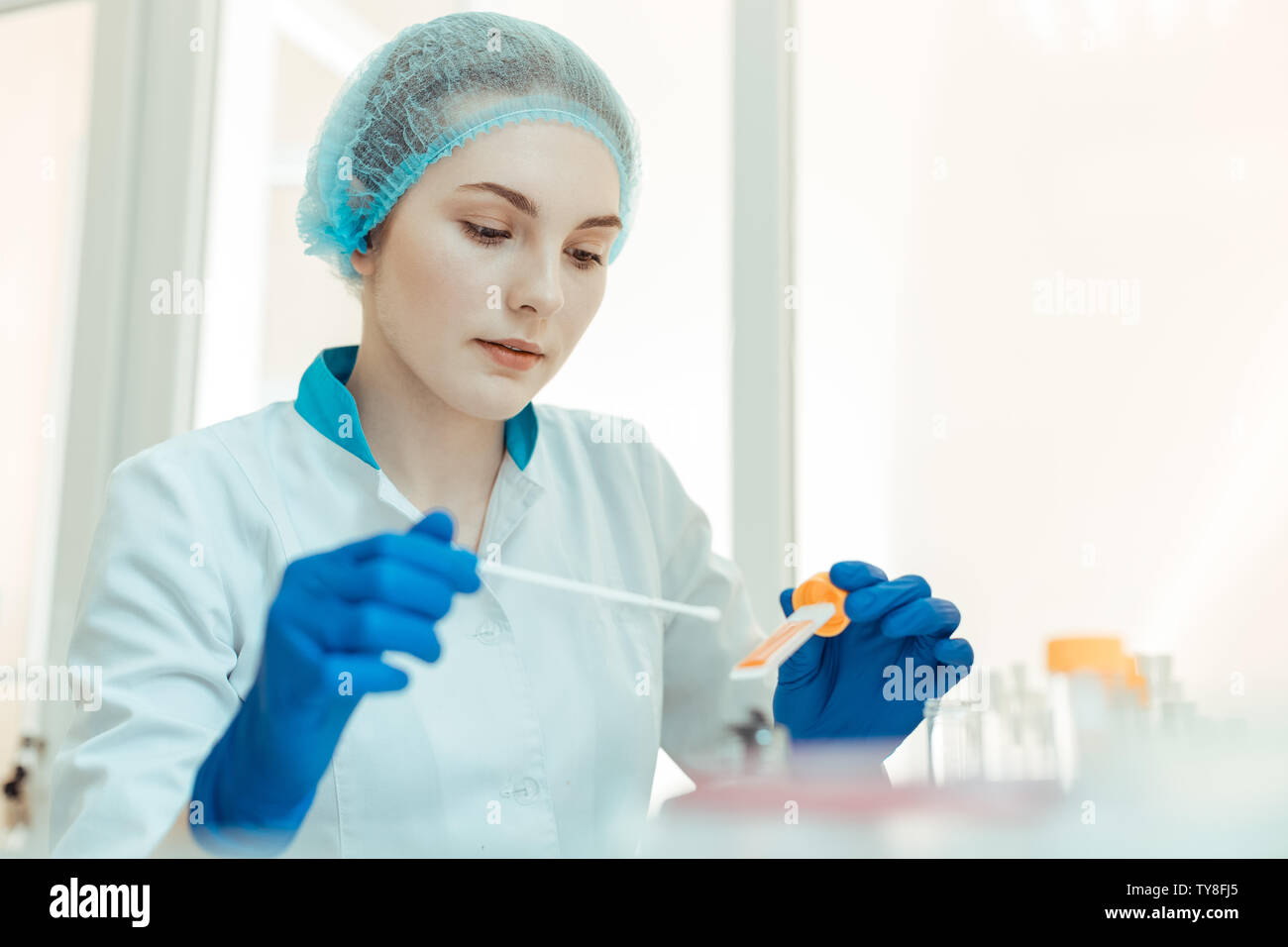 Female lab worker examining sample hi-res stock photography and images ...