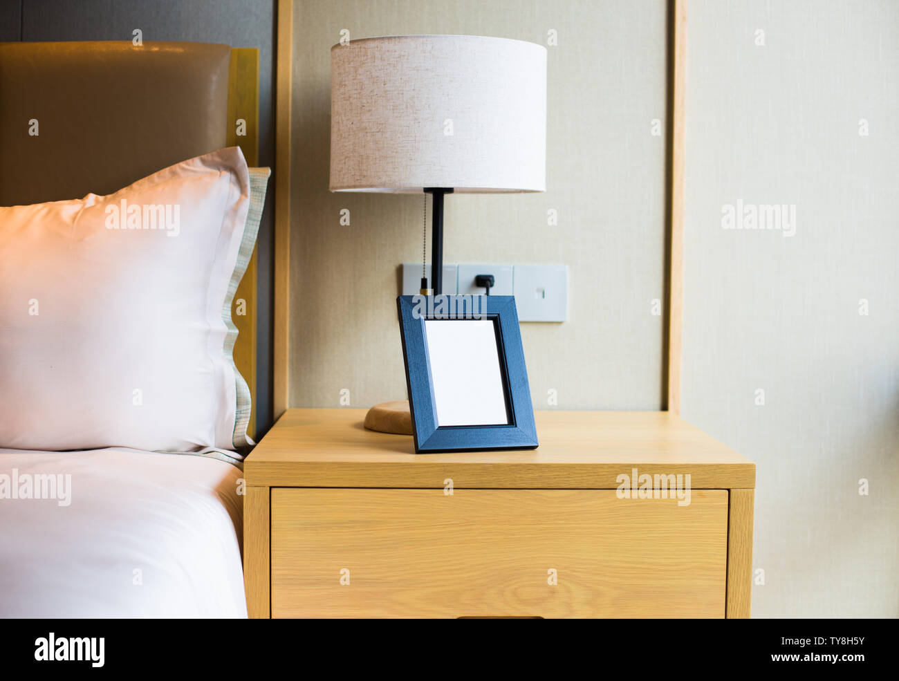 night table with frame in modern bedroom Stock Photo - Alamy