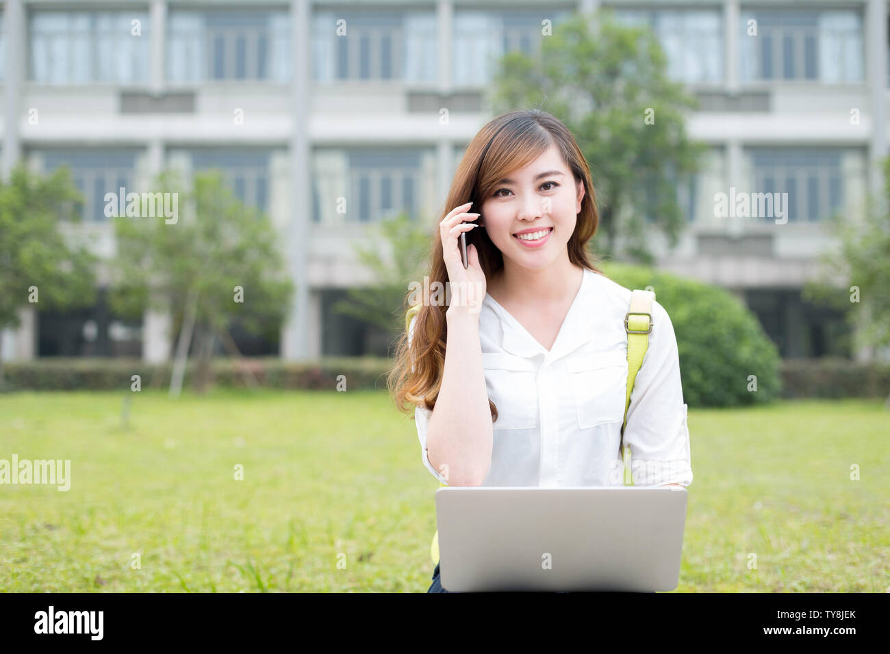 Asian beautiful female student using laptop in campus Stock Photo - Alamy