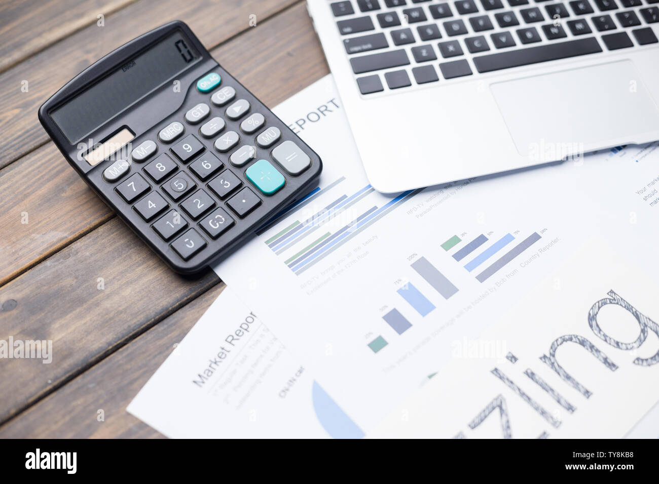 laptop and calculator on financial report Stock Photo - Alamy