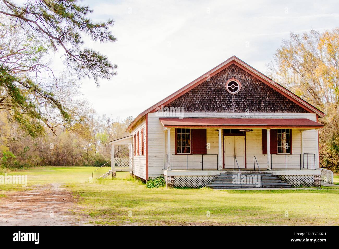 Wooden house built in a large green field Stock Photo - Alamy
