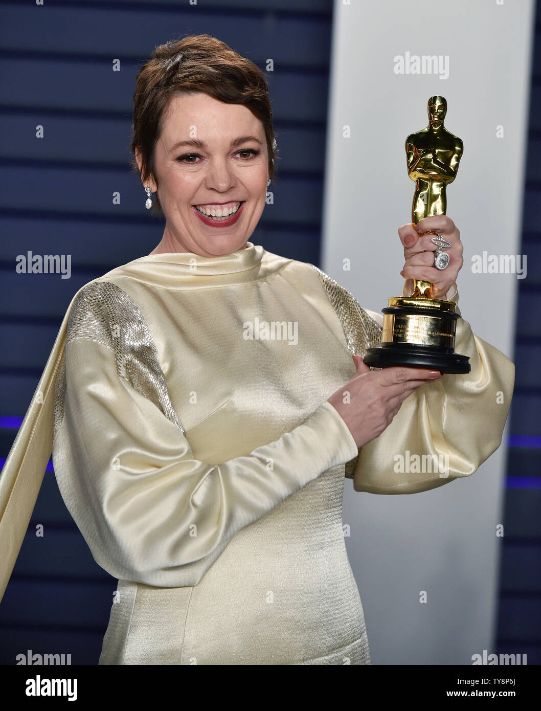 Olivia Colman holds up her Best Actress Oscar as she arrives for the ...