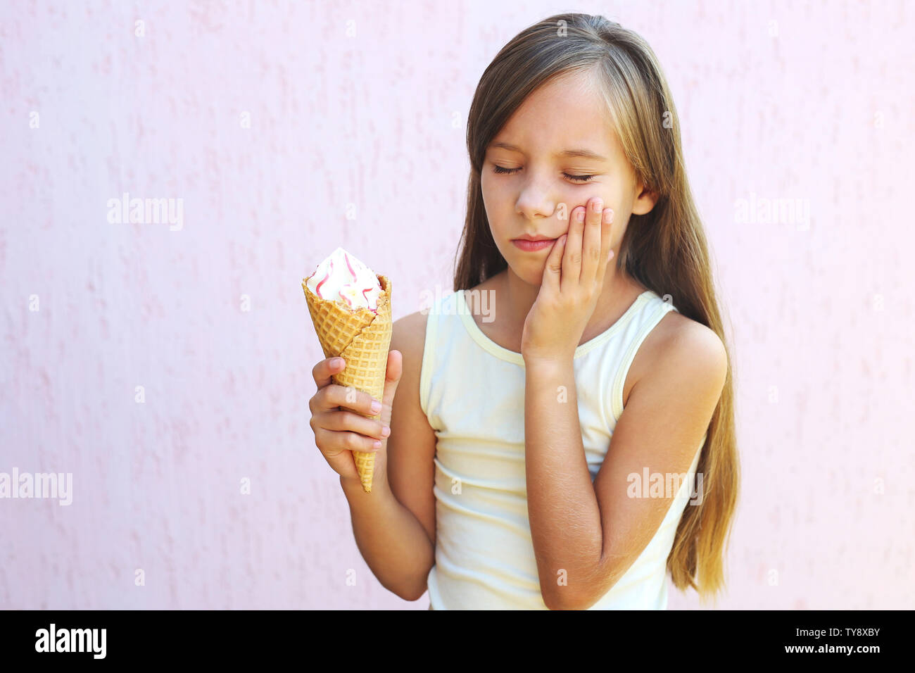 Girl has a toothache from cold ice cream Stock Photo - Alamy