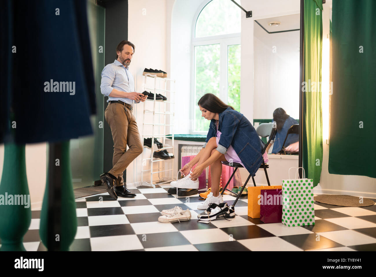 Woman trying on clothes man hi-res stock photography and images - Alamy