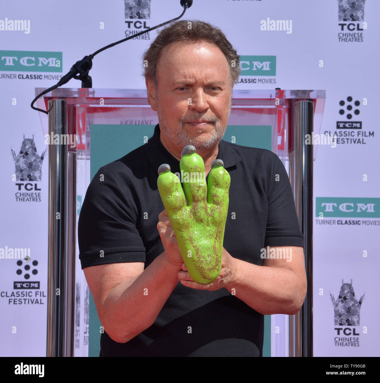 Actor and comedian Billy Crystal holds up a prop from his 1979 movie ...