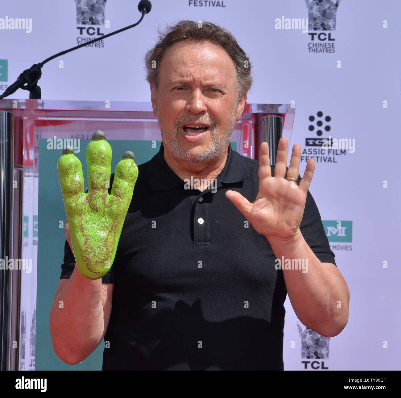 Actor and comedian Billy Crystal holds up a prop from his 1979 movie ...