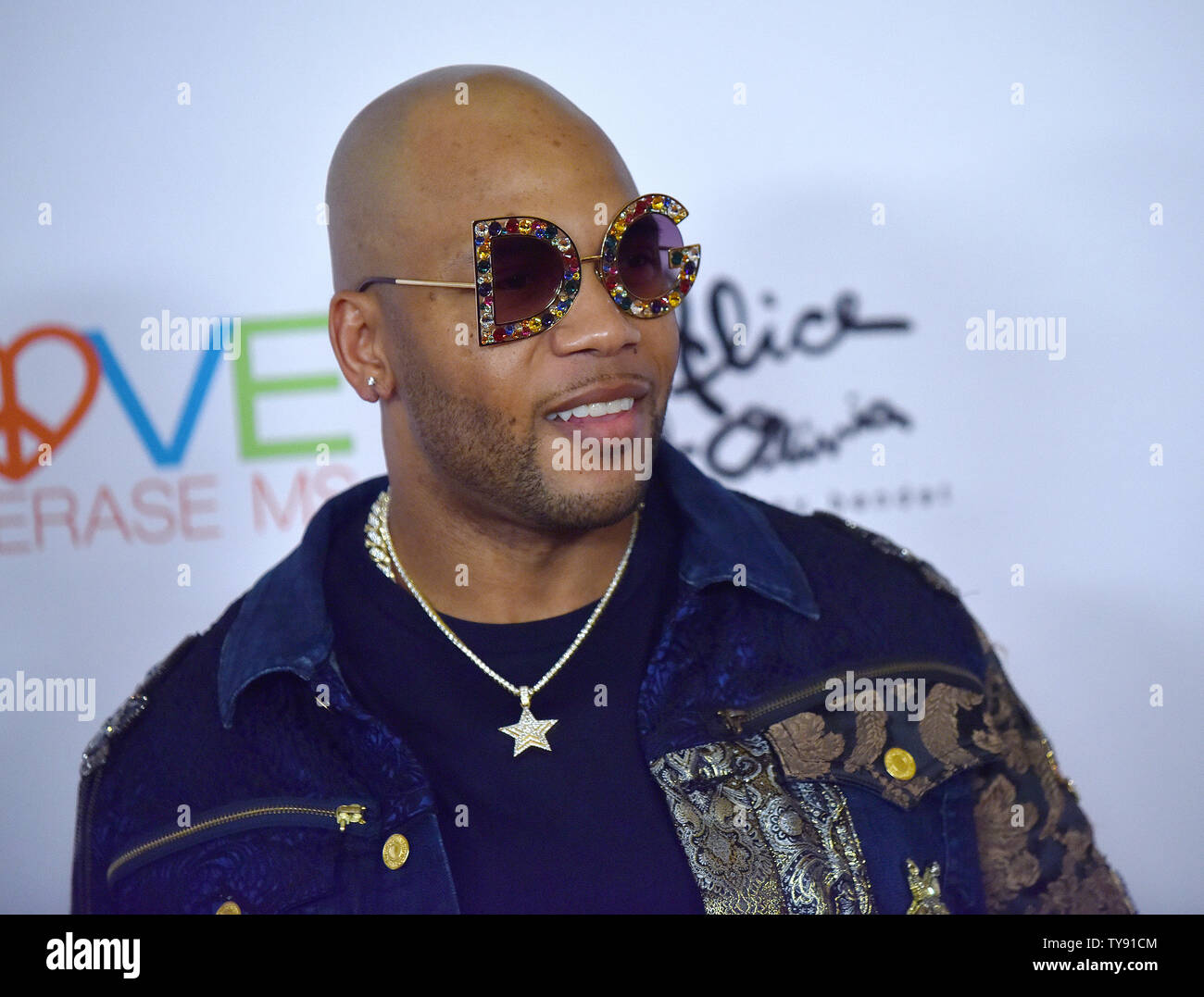 Flo Rida arrives on the orange carpet for the 26th Annual Race to Erase ...