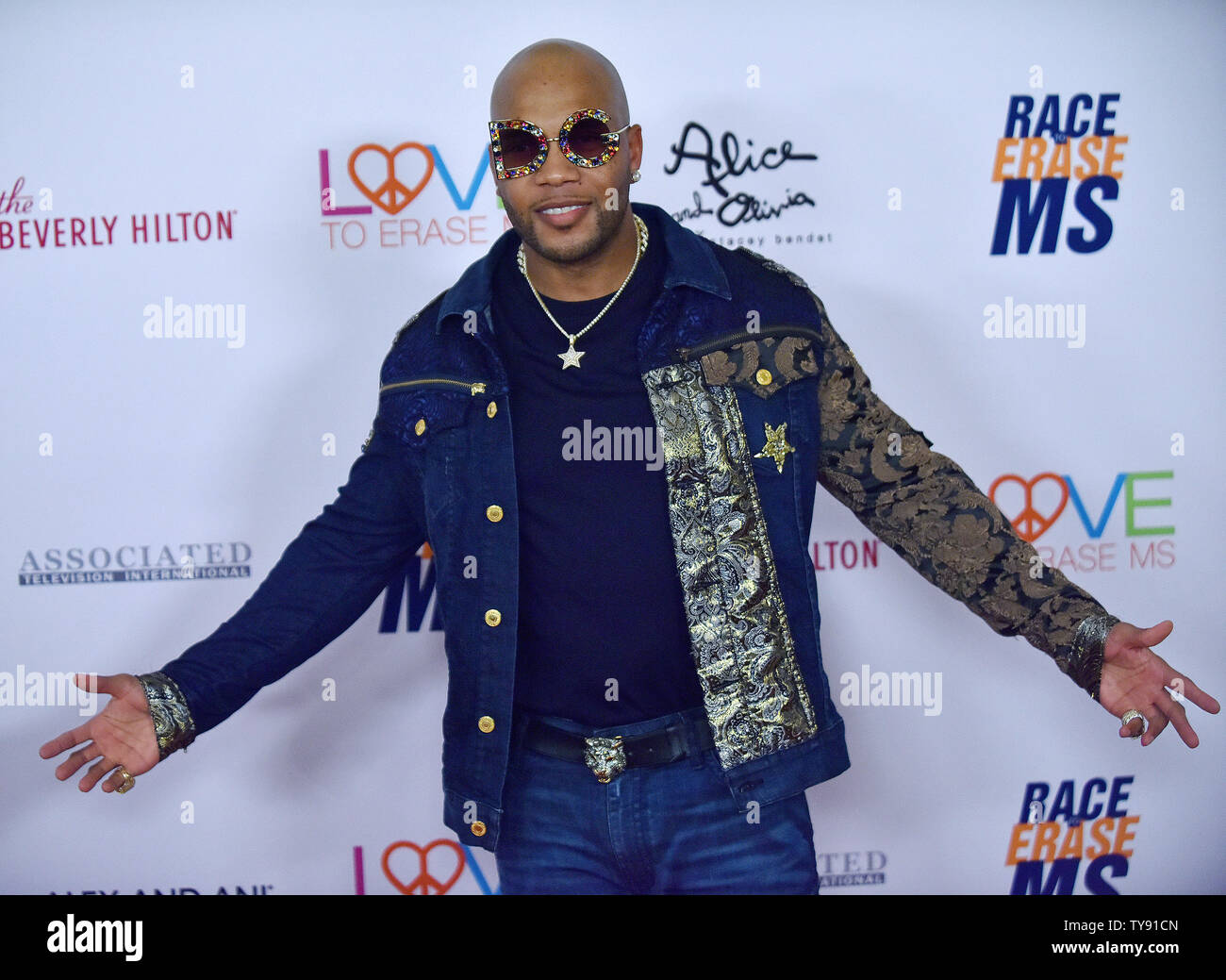Flo Rida arrives on the orange carpet for the 26th Annual Race to Erase ...