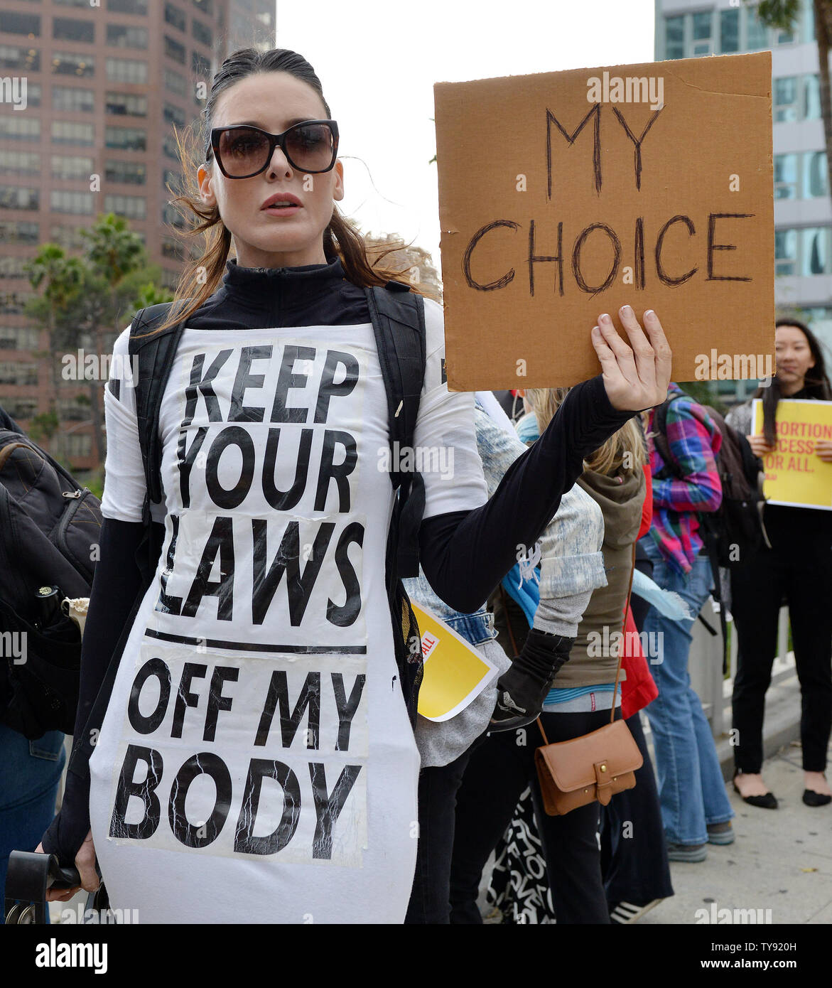 An abortion rights advocate makes a statement with her dress and sign at a Stop Abortion Bans ...