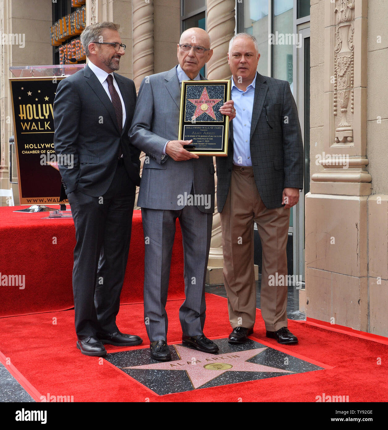 Actor Alan Arkin (C) holds a replica plaque as he is joined by actor ...