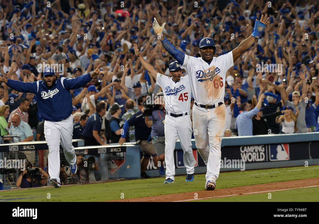 Los Angeles Dodgers right fielder Yasiel Puig (66) and third base coach ...
