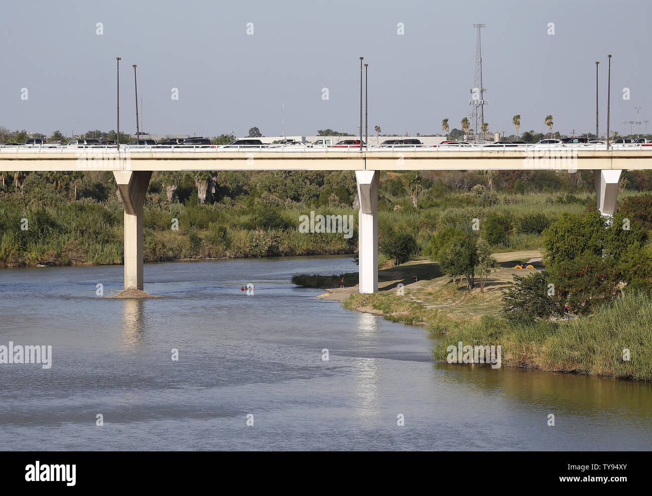 People wade in the Rio Grande River near the Gateway to the Americas ...