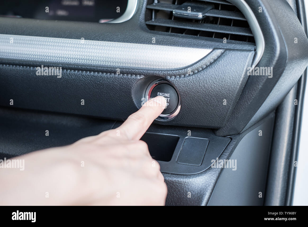 Driver finger pressing start engine car on control panel Stock Photo ...