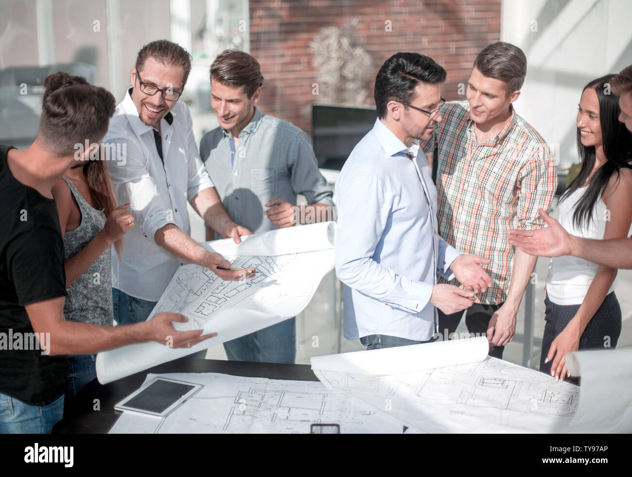 group of designers and architects discussing new sketches Stock Photo ...