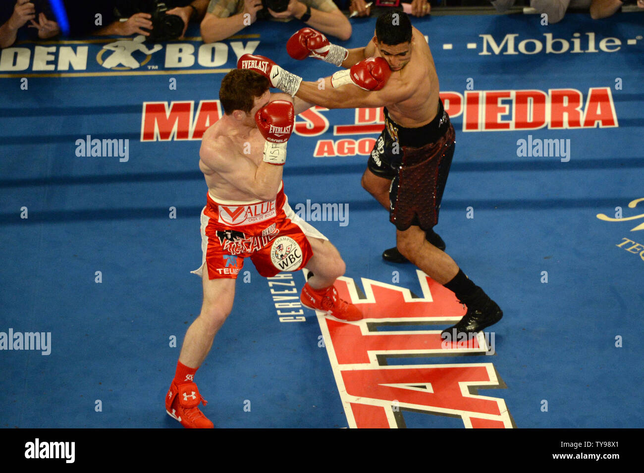 Canelo Alvarez lands a punch on Amir Khan in the first round of their ...