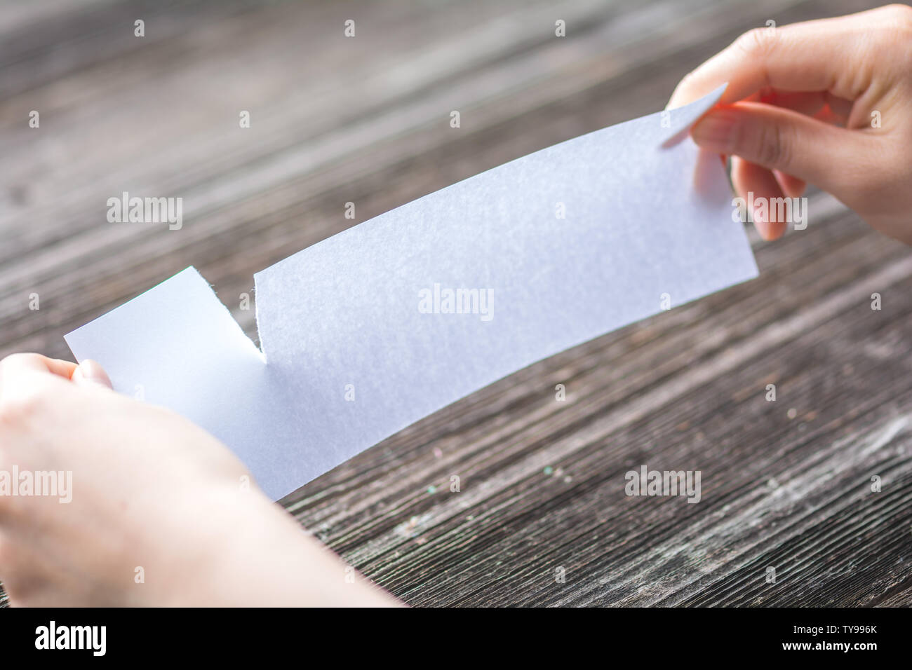 Tearing paper hands hi-res stock photography and images - Alamy