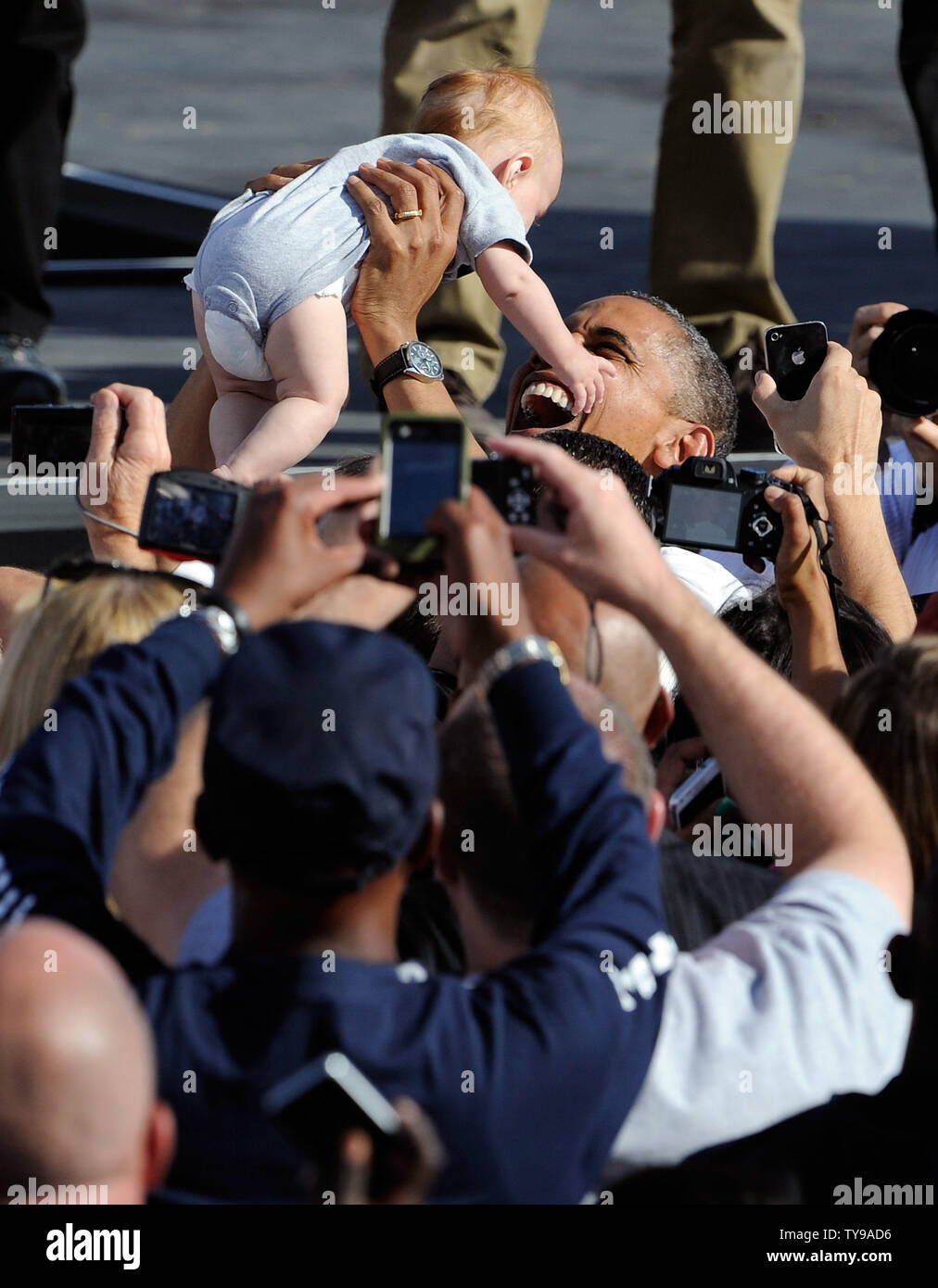 President Barack Obama holds up five-month-old Michael Mitchell Jr ...