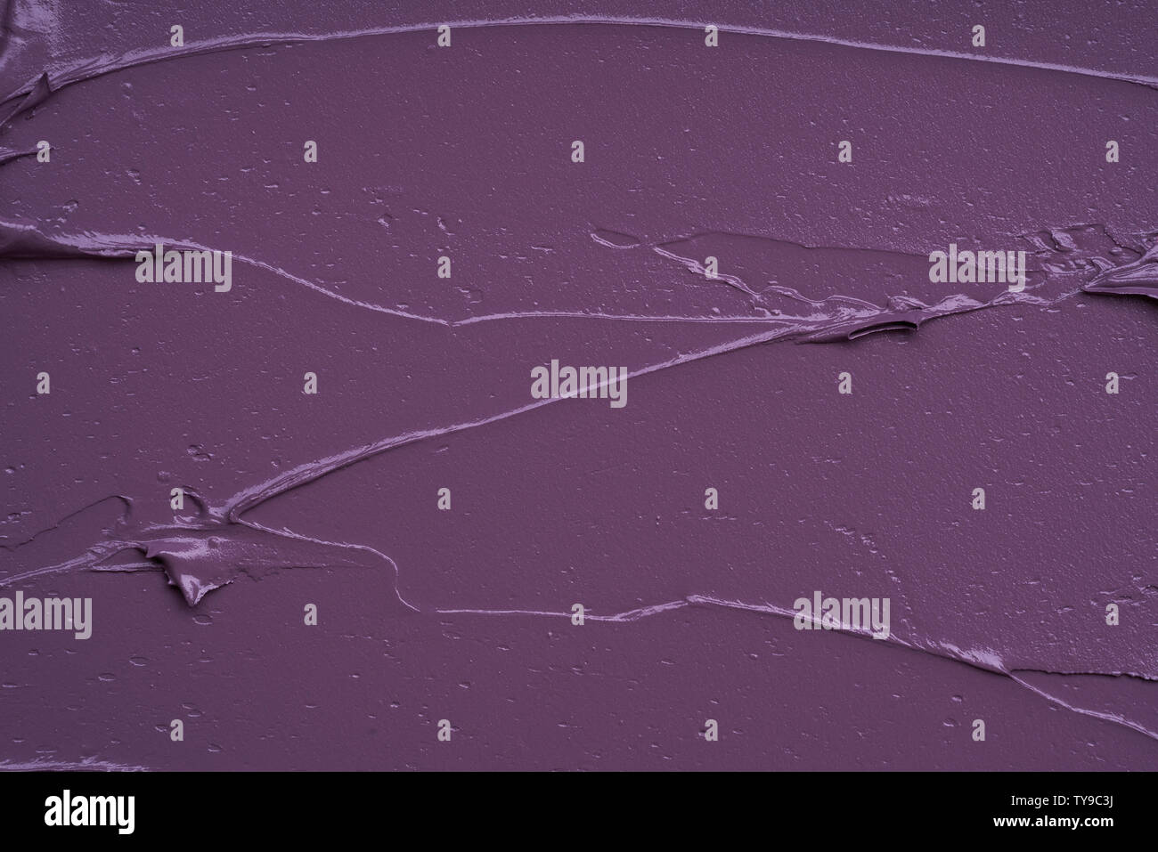 Pale purple smears and texture mascara or acrylic on a white background ...