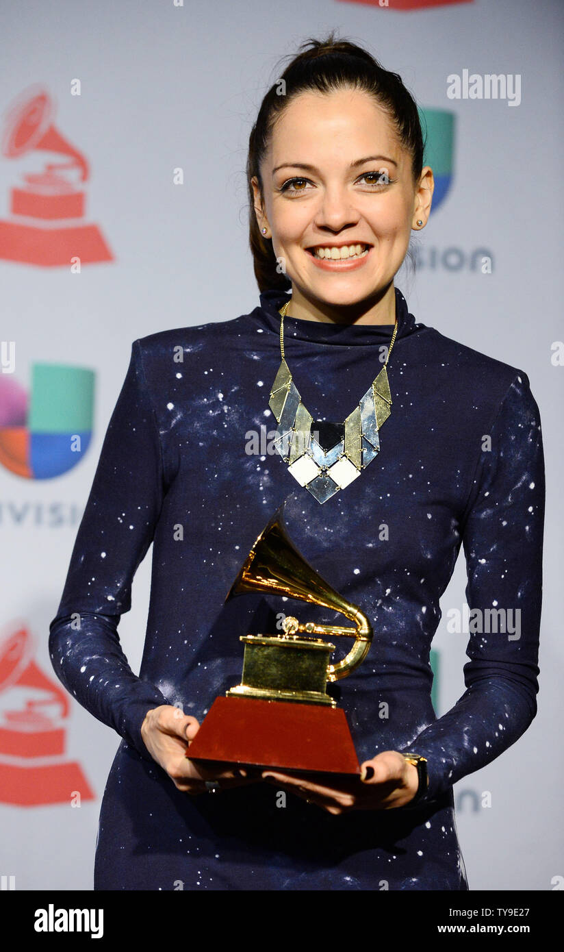 Singer-songwriter Natalia Lafourcade holds the award she won for Best ...