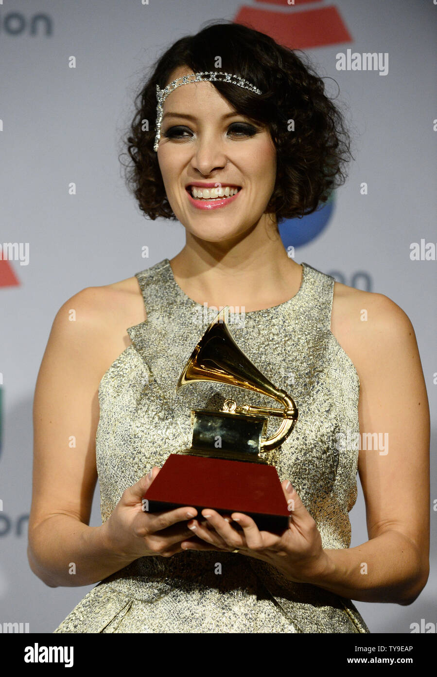 Recording artist Gaby Moreno holds the award she won for Best New ...