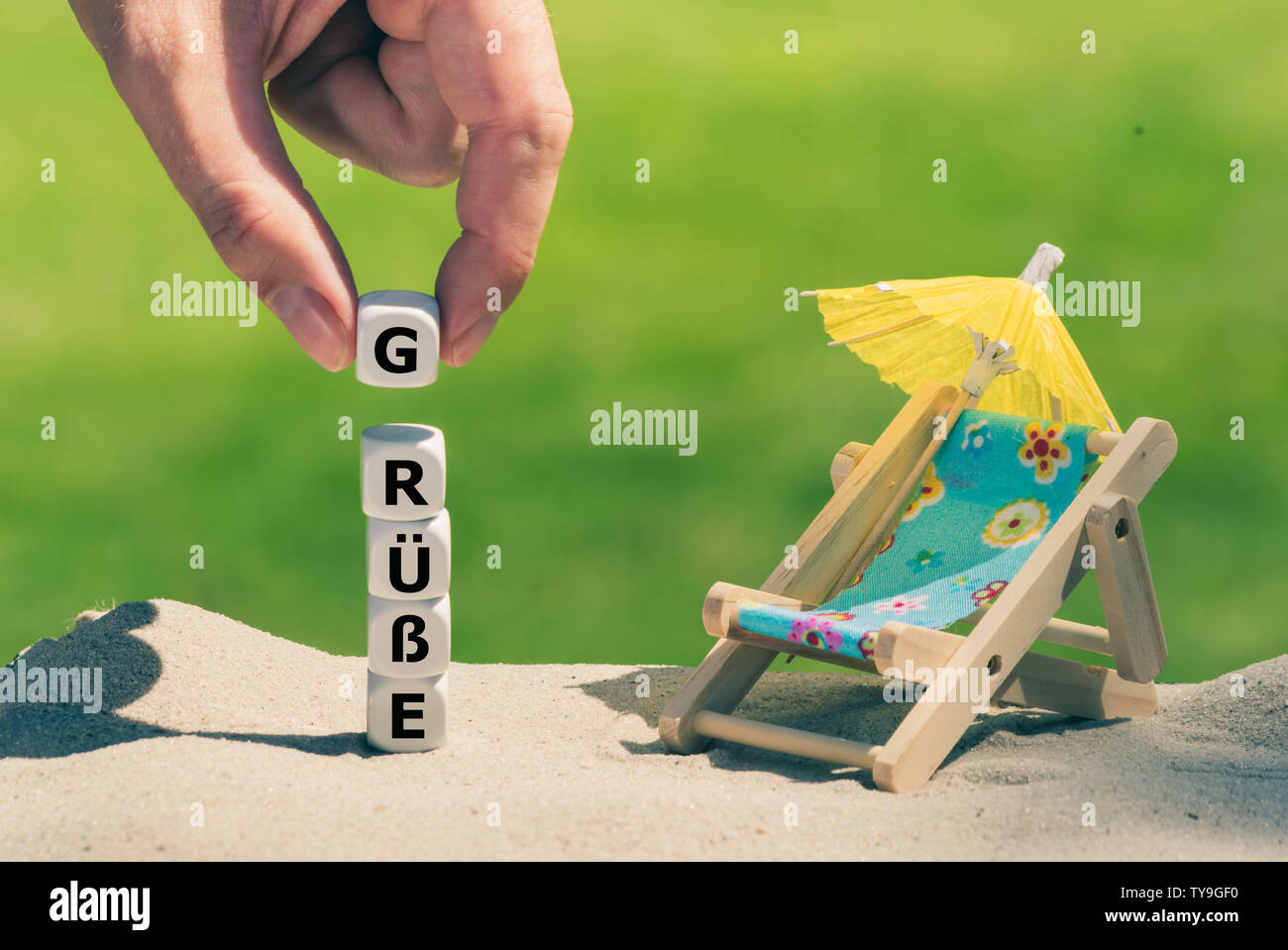 Dice form the German word "Gruesse" ("greetings" in English) next to a ...