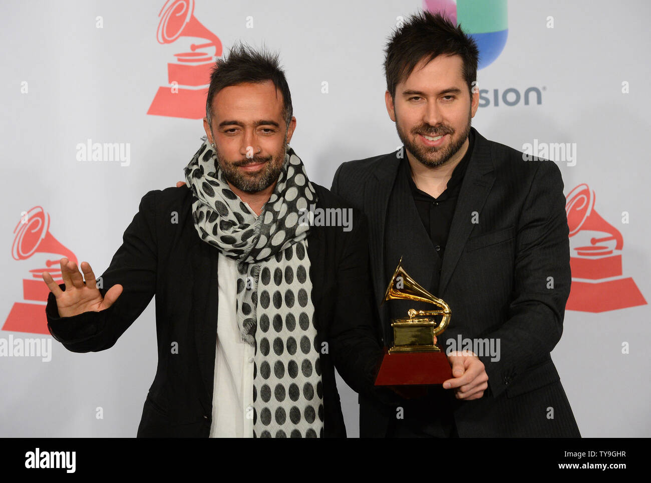 Members of the musical group Camila pose backstage with the award for ...