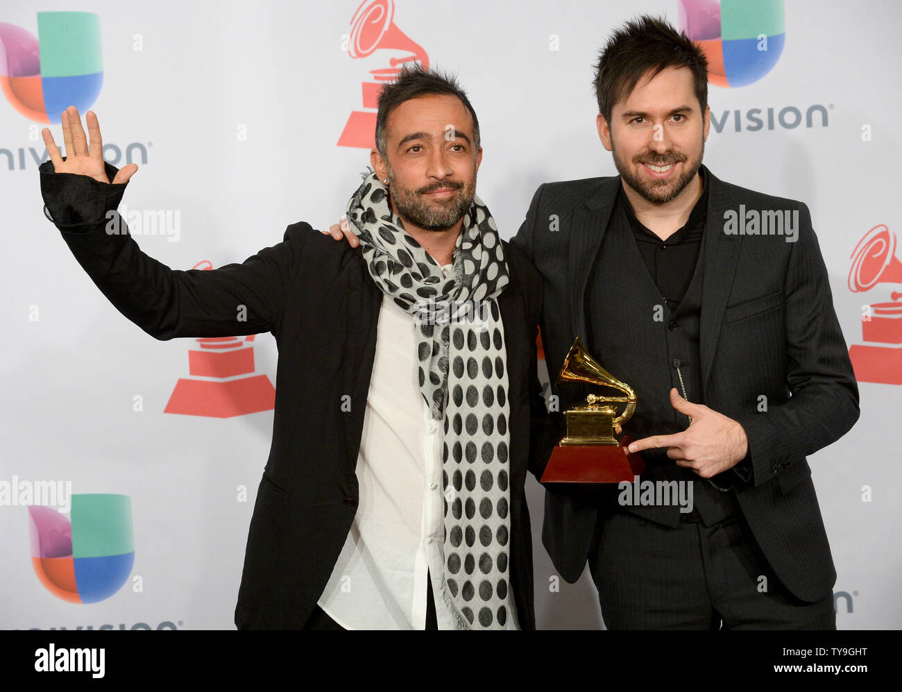 Members of the musical group Camila pose backstage with the award for ...
