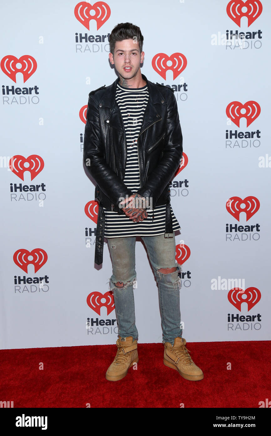 Travis Mills arrives in the press room for the iHeartRadio Music ...